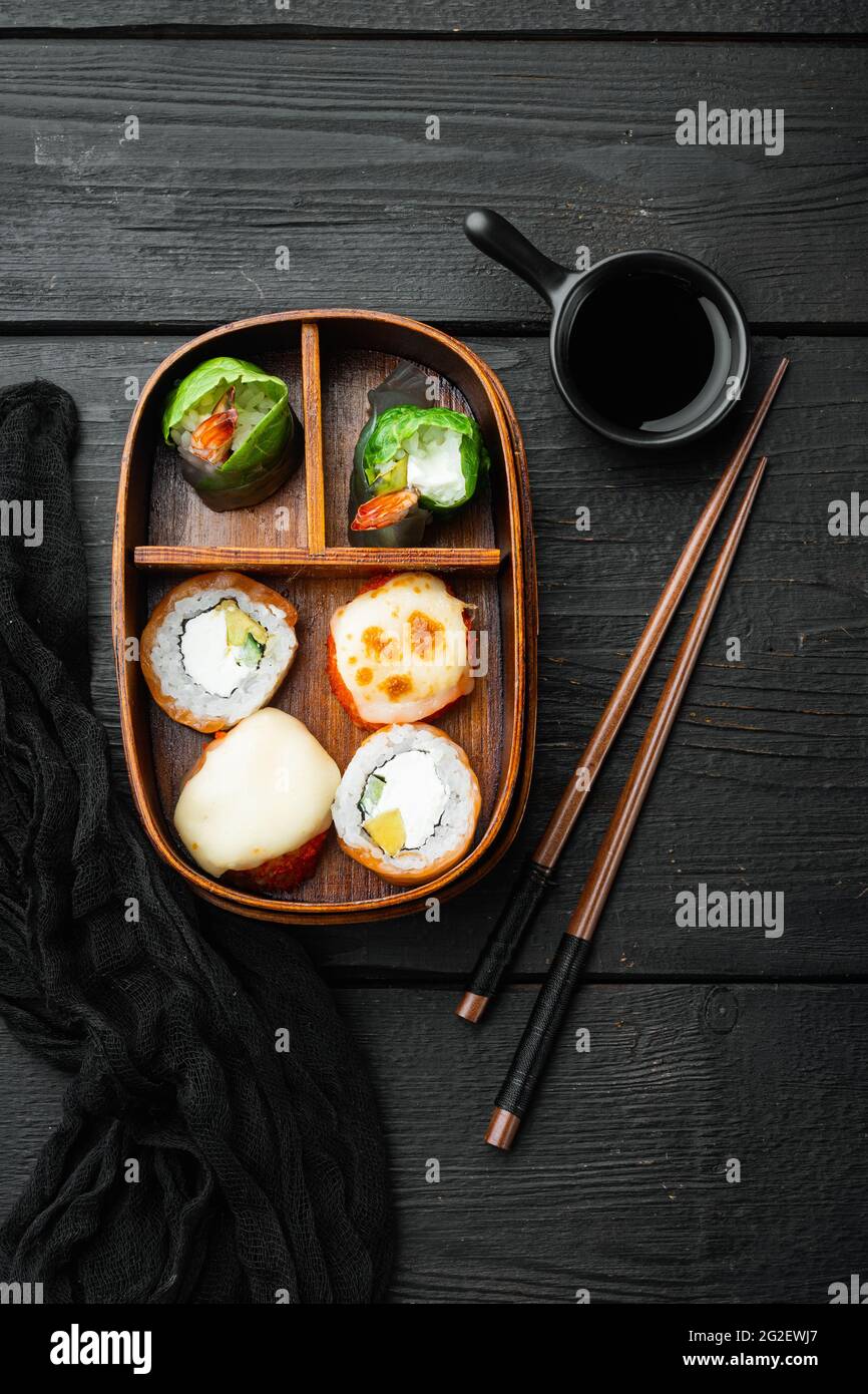 Homemade Sushi Bento Box with Sushi Rolls set, on black wooden table ...