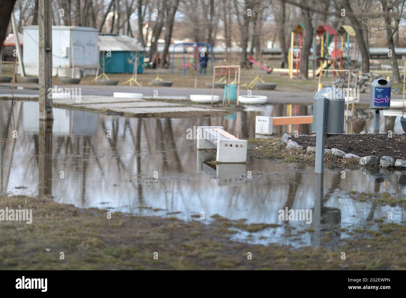 a huge puddle of water right on the playground Stock Photo - Alamy