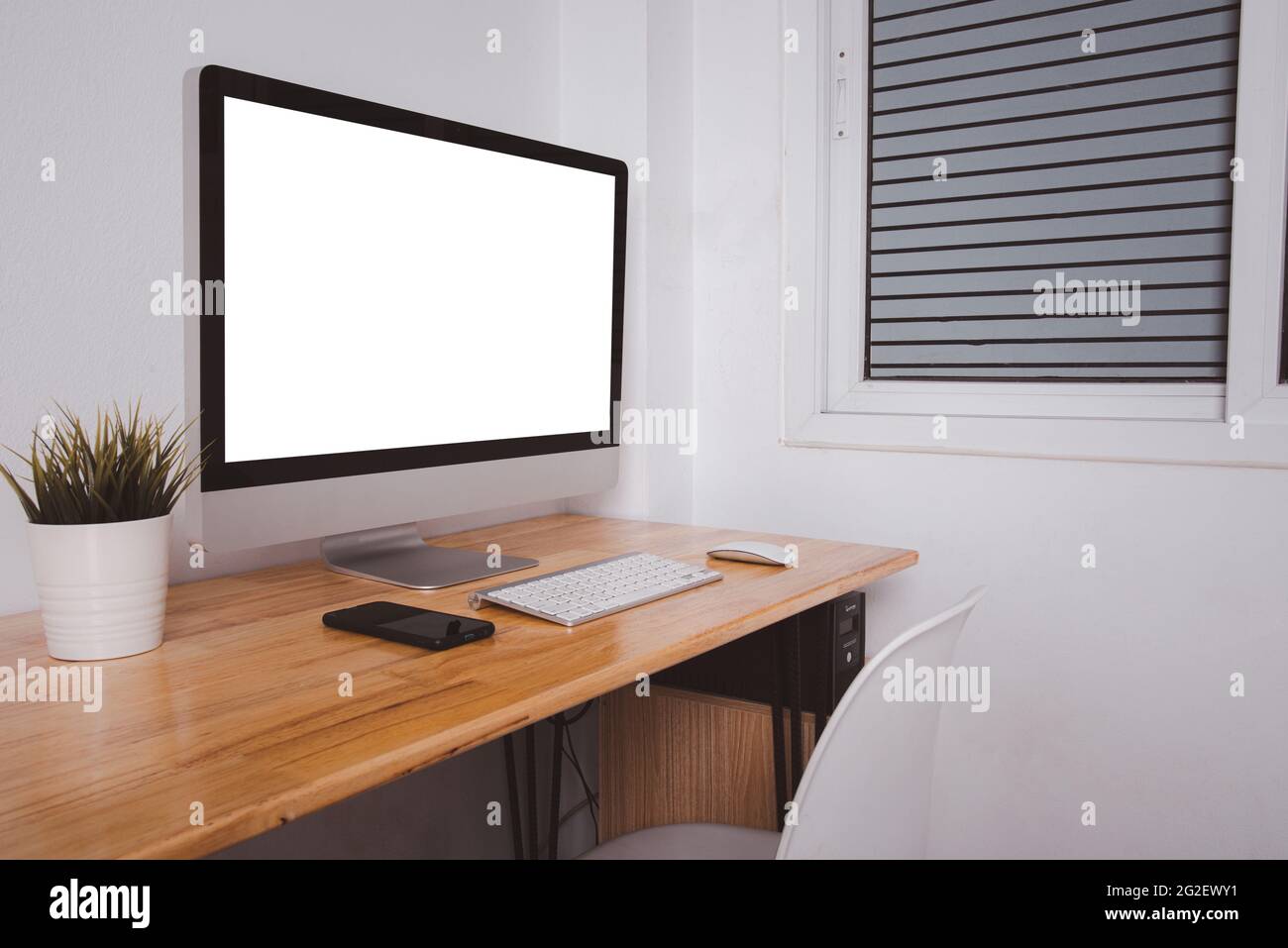 Computer monitor with white blank screen on the business desk with ...
