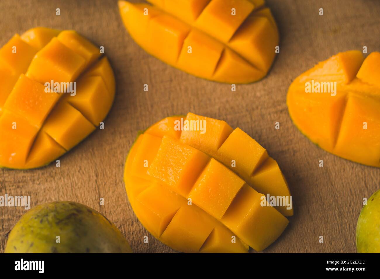 Alphonso mango slices on wooden background stock image with selective ...