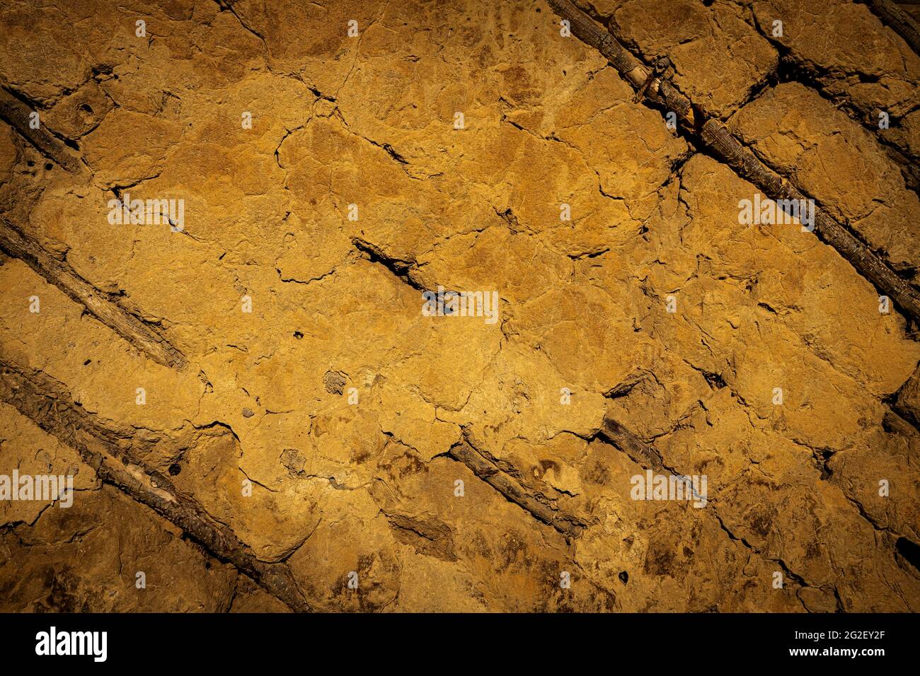 texture or background of old destroyed clay wall with wood inserts ...