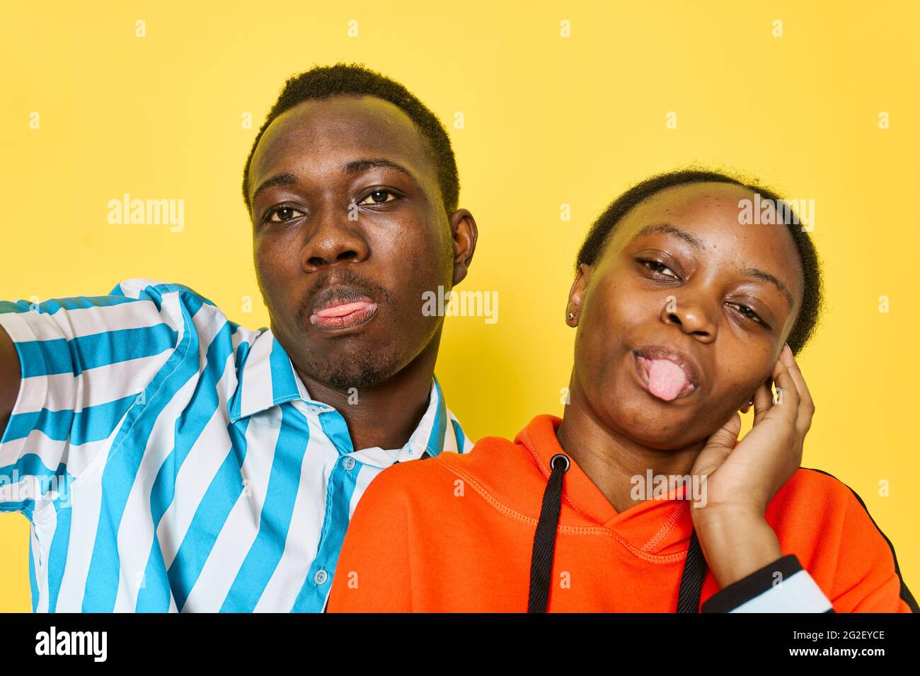 young couple of african appearance together on yellow background Stock ...