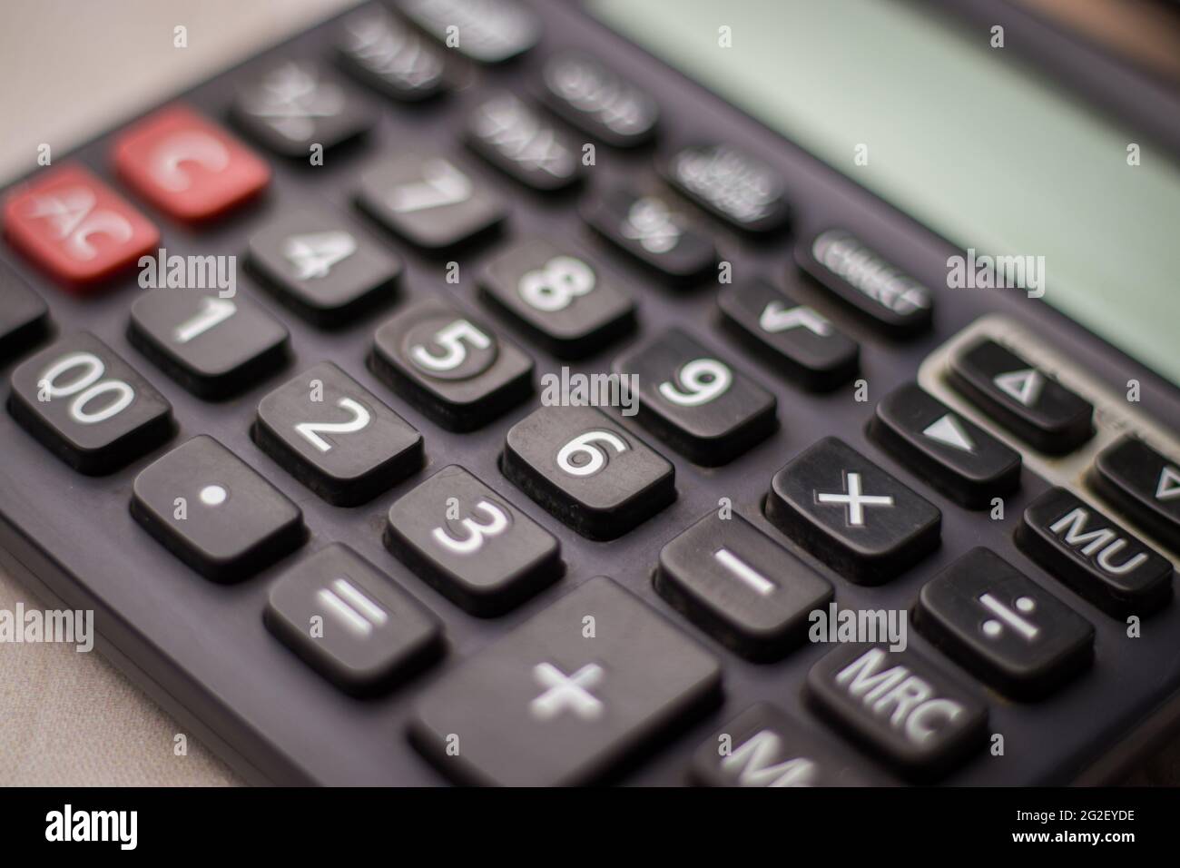 Black calculator on texture background stock image Stock Photo - Alamy