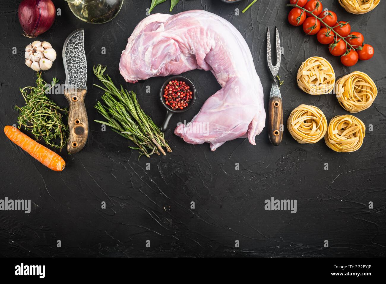 Raw whole rabbit with fresh vegetables and pasta for rabbit stew set ...