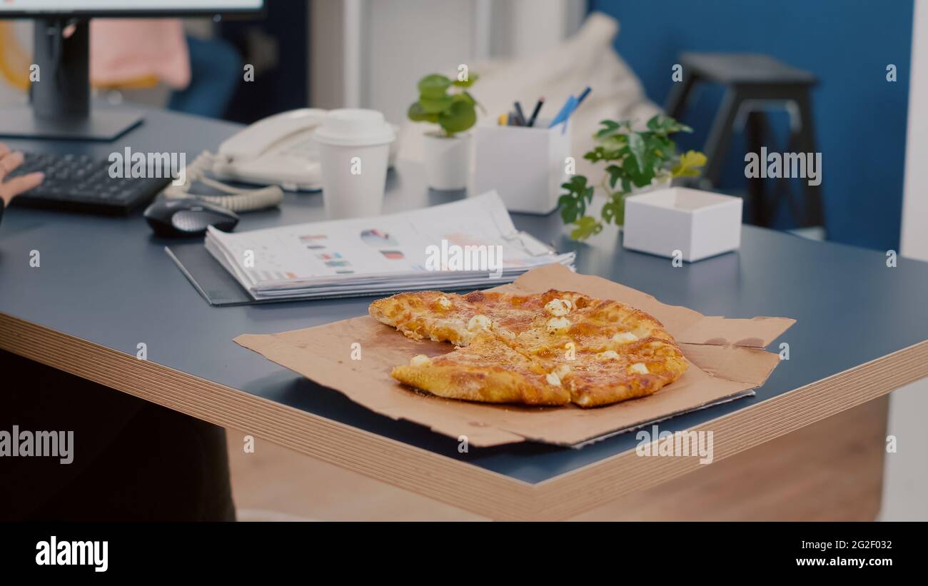 Closeup of executive manager taking slice of pizza eating in front of ...