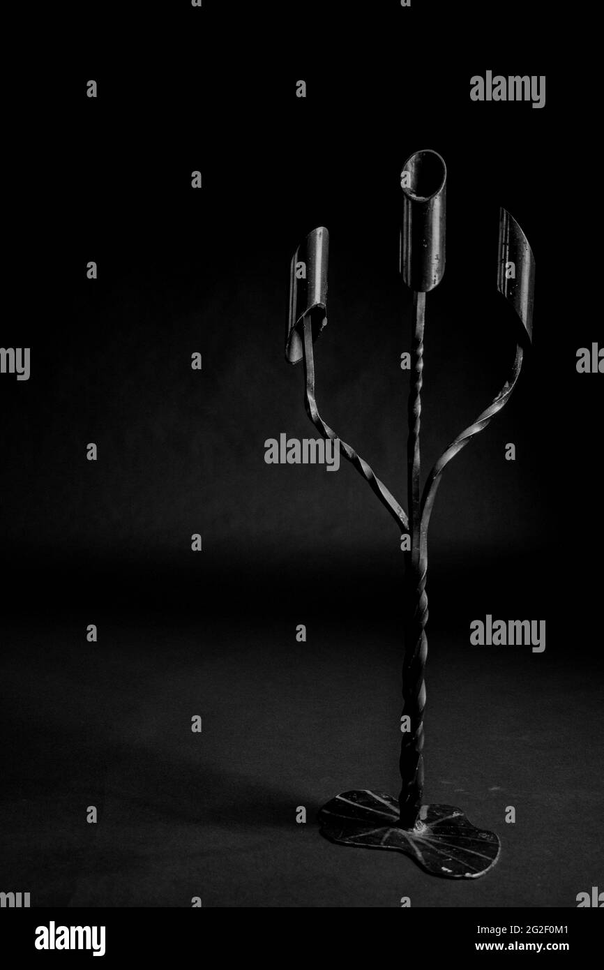 Metal candlestick on black background Stock Photo - Alamy