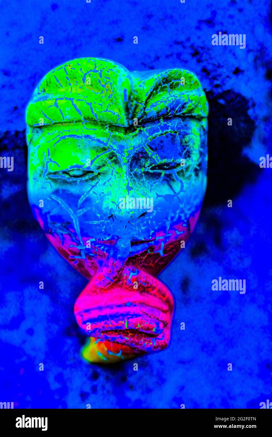 A Bali face mask with finger on its mouth Stock Photo - Alamy