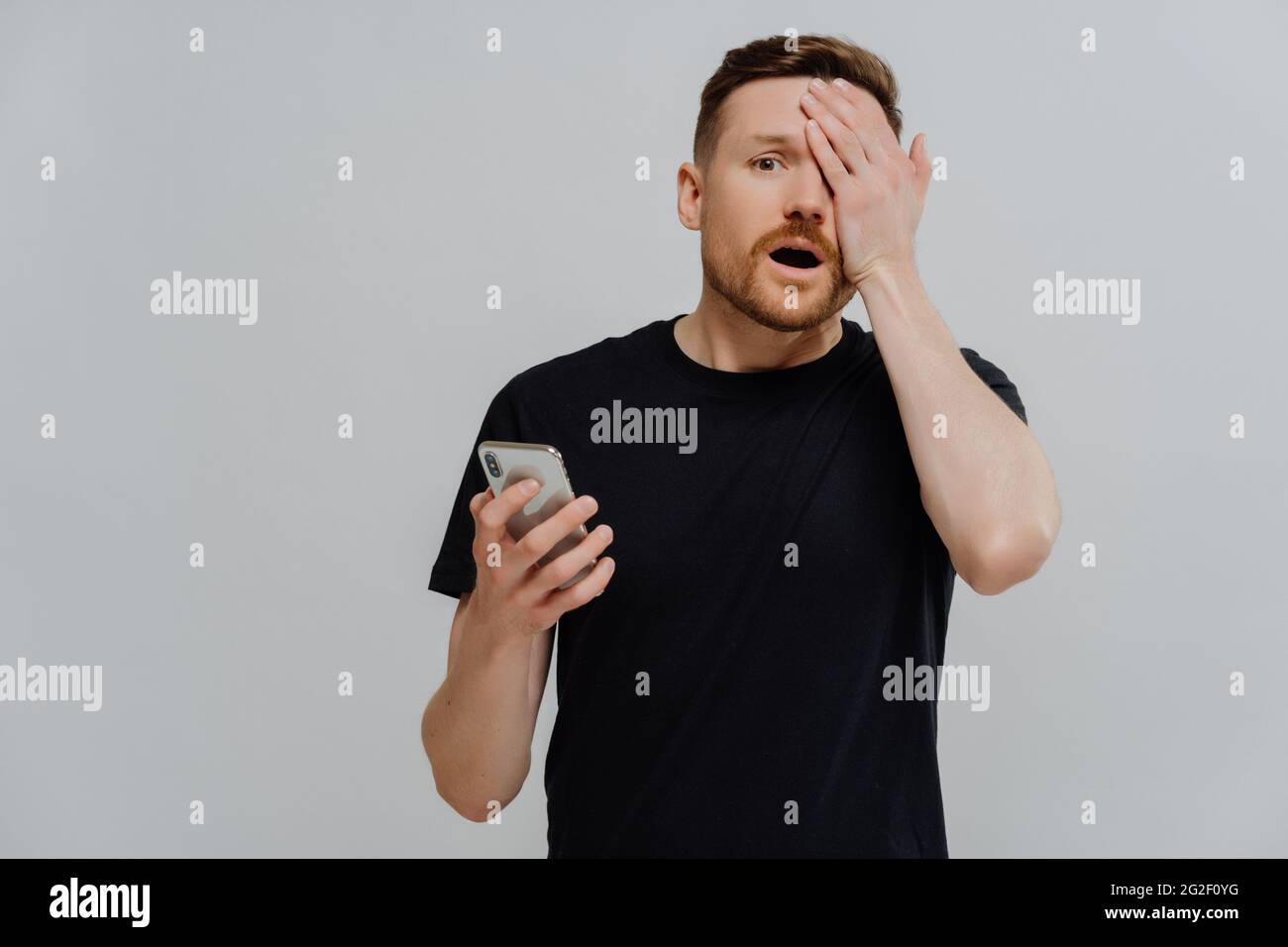 Stressed guy receiving message with bad news on smartphone, being in ...