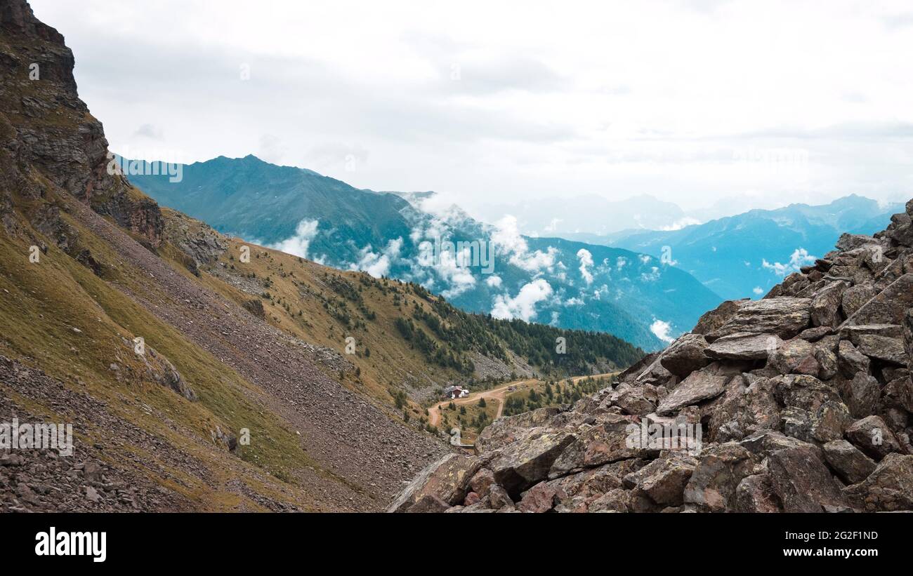 A pile of rocks in the Italian Alps with a view of the mountains and ...