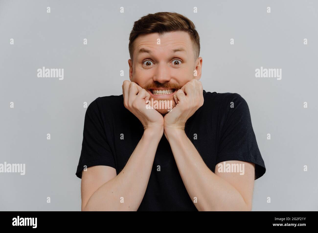 Scared shocked young unshaven man being afraid of something or feeling ...