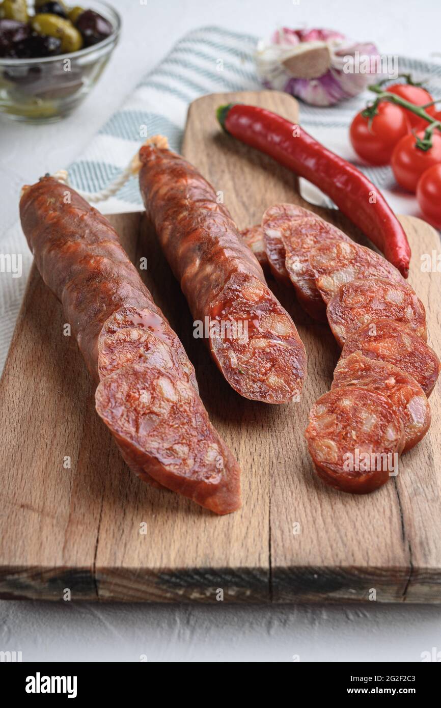 Traditional chorizo cuts with spices and ingredients on white surface ...