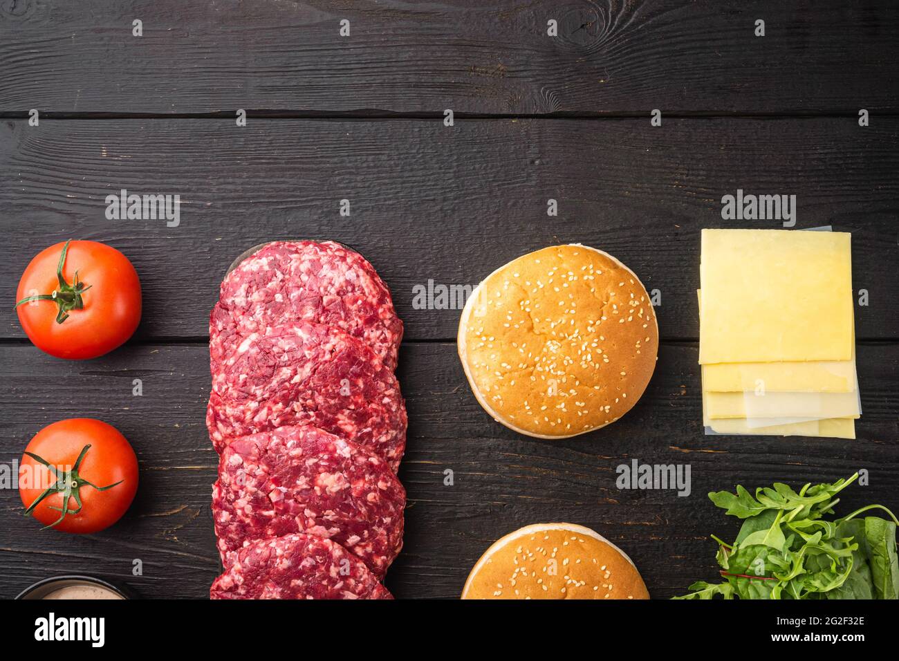 Beef burger ingredients set, on black wooden table background, top view ...