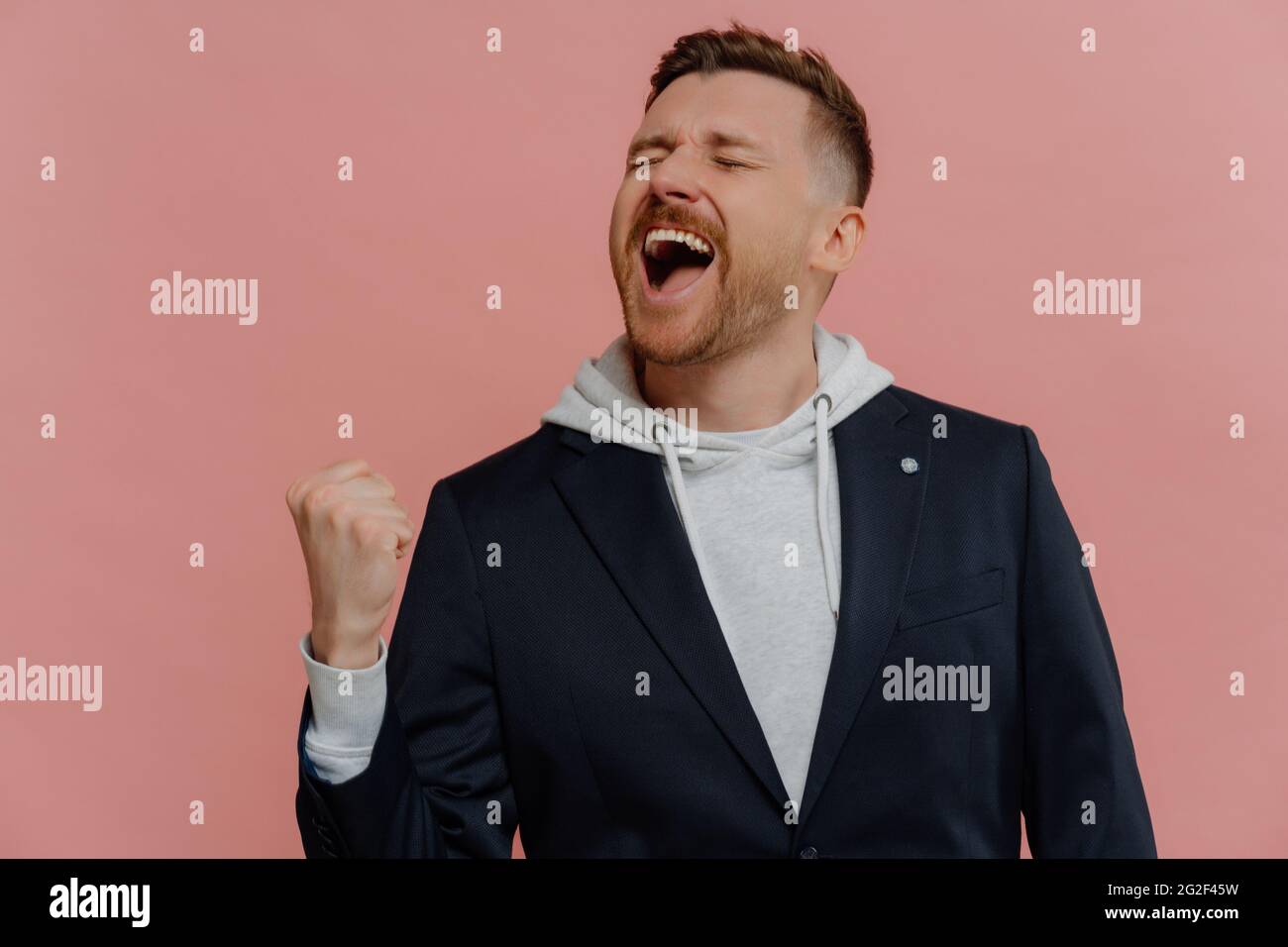 Overjoyed man raising clenched fist and celebrating achievements Stock ...