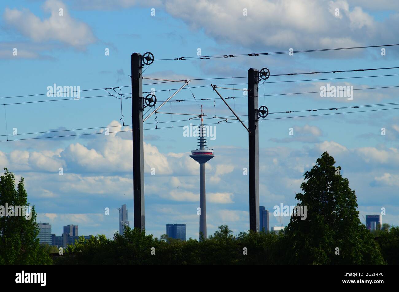 Catenary masts frame the Frankfurt TV tower Stock Photo - Alamy