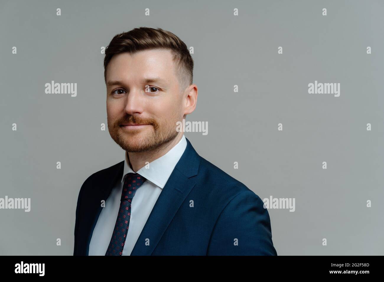 Confident happy executive manager looking at camera and smiling while ...