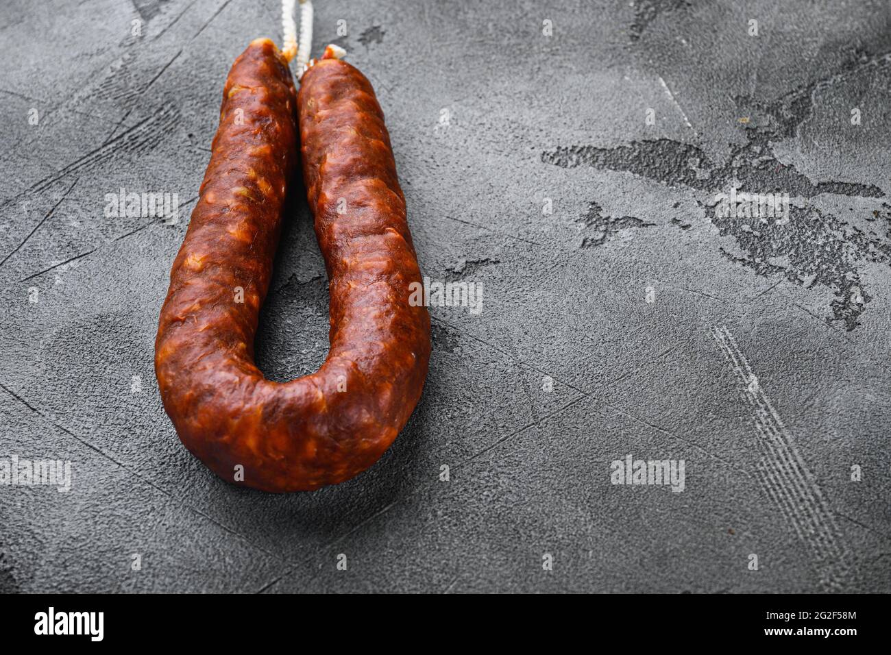Spanish sausage chorizo salami on grey textured background with copy ...