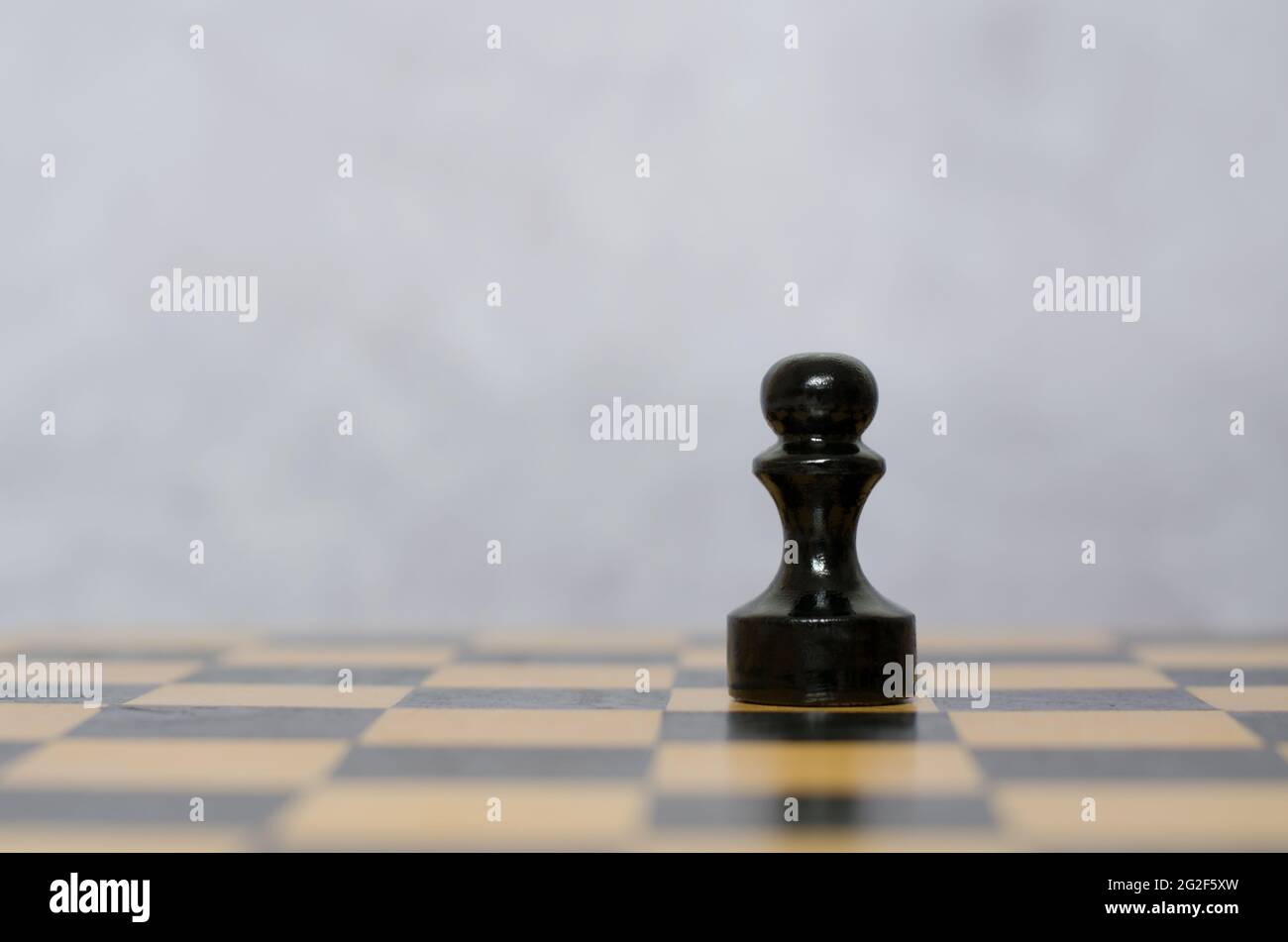 Wooden black pawn on a chessboard. Chess pieces, side view Stock Photo ...