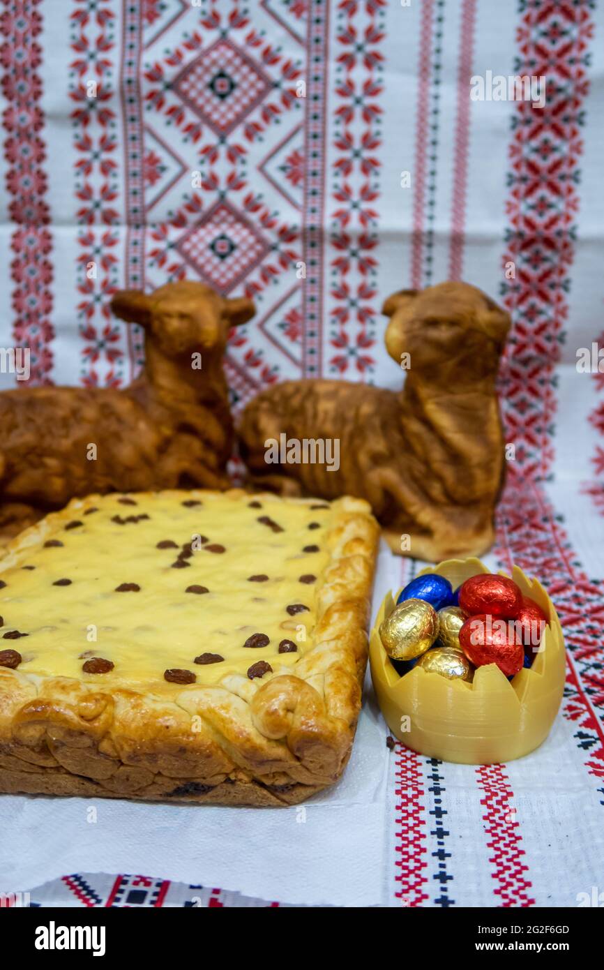 Traditional pasca with raisins, colored egg-shaped sweets, and dough ...