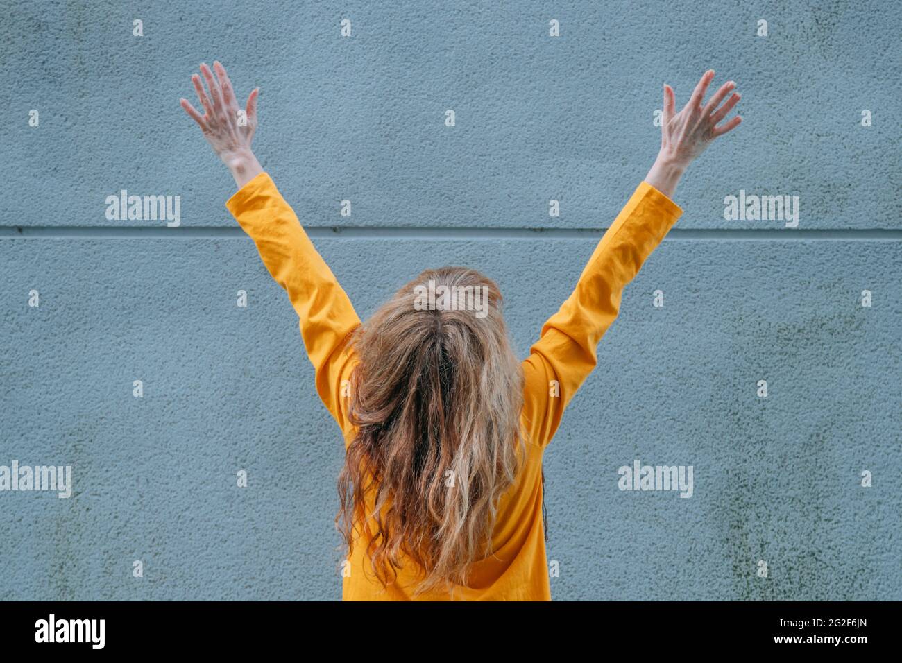 woman with arms raised in the street Stock Photo - Alamy