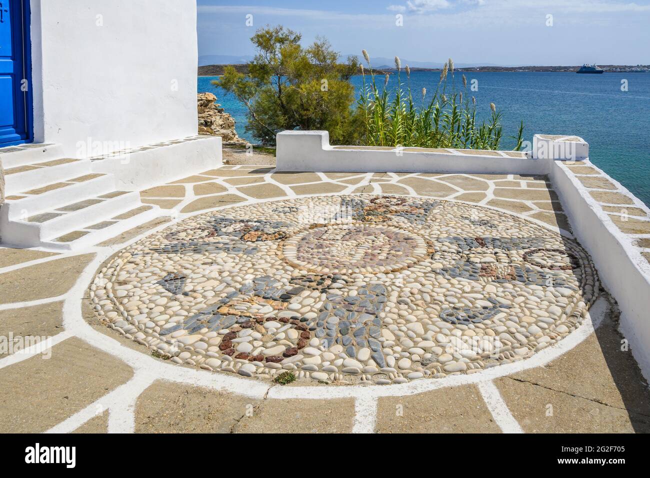 Decorative Greek pebble mosaic and sea view. The church of Agios ...