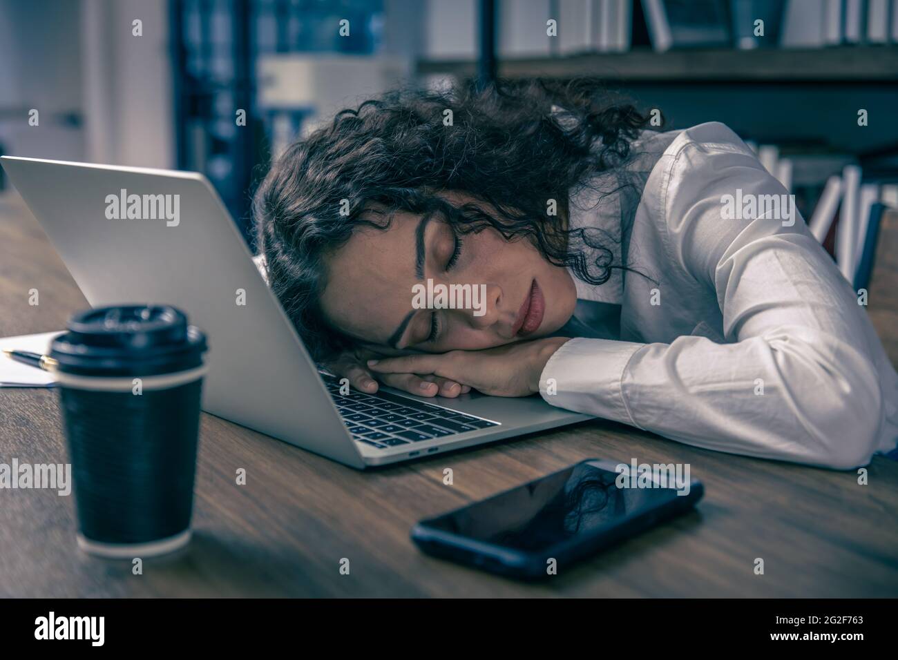 Tired working women sleeping at office desk hard work overnight nap ...
