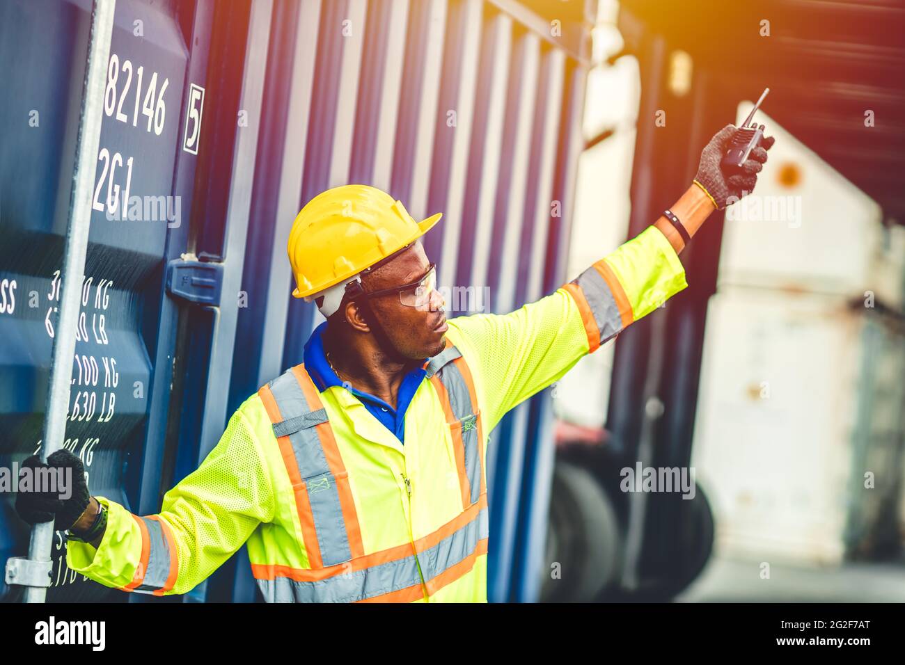 Black African worker working in logistic shipping radio control order ...