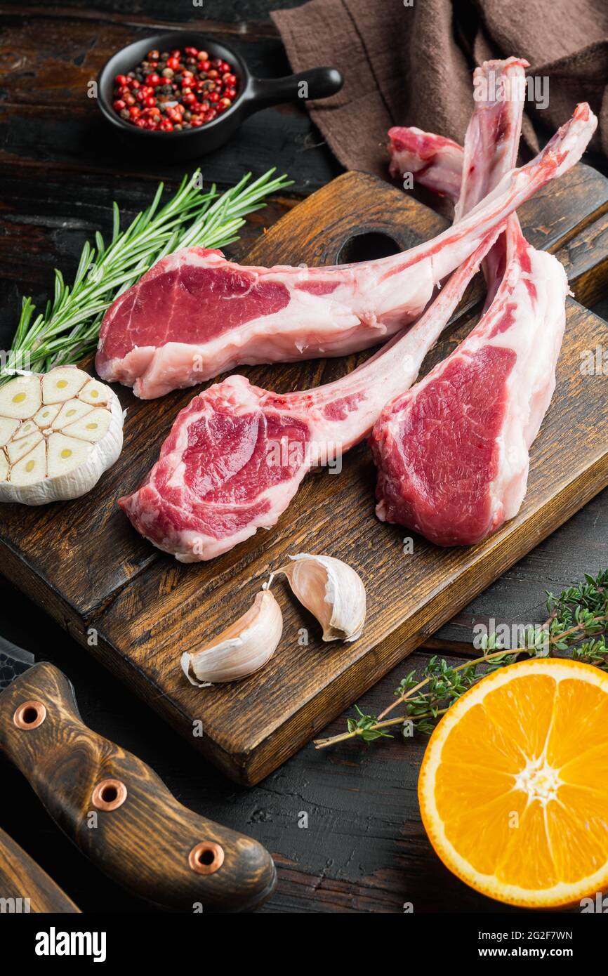 Frenched raw fatty lamb chops set, with ingredients carrot orange ...