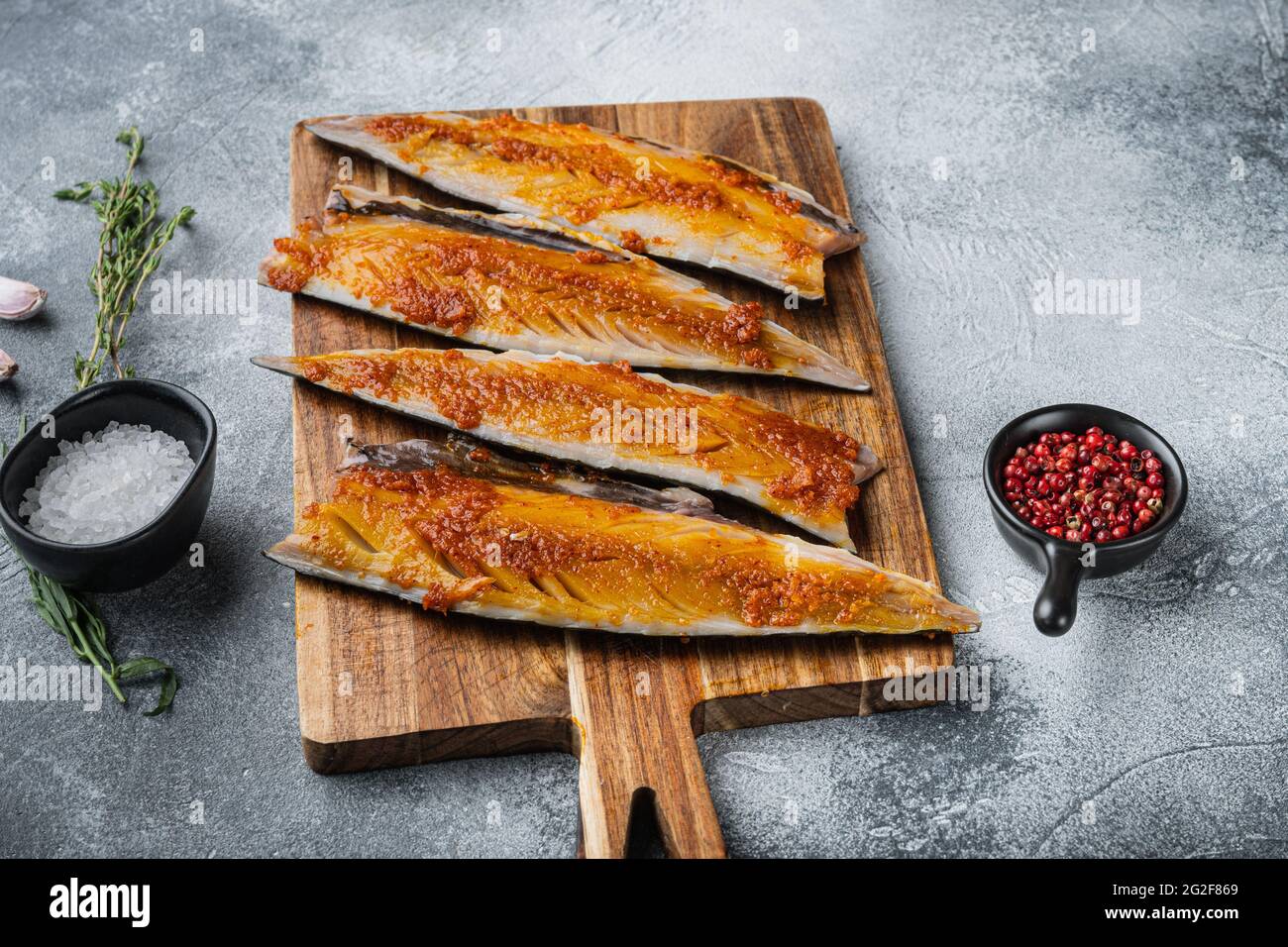 Marinated mackerel with garlic and saffron on grey background Stock ...