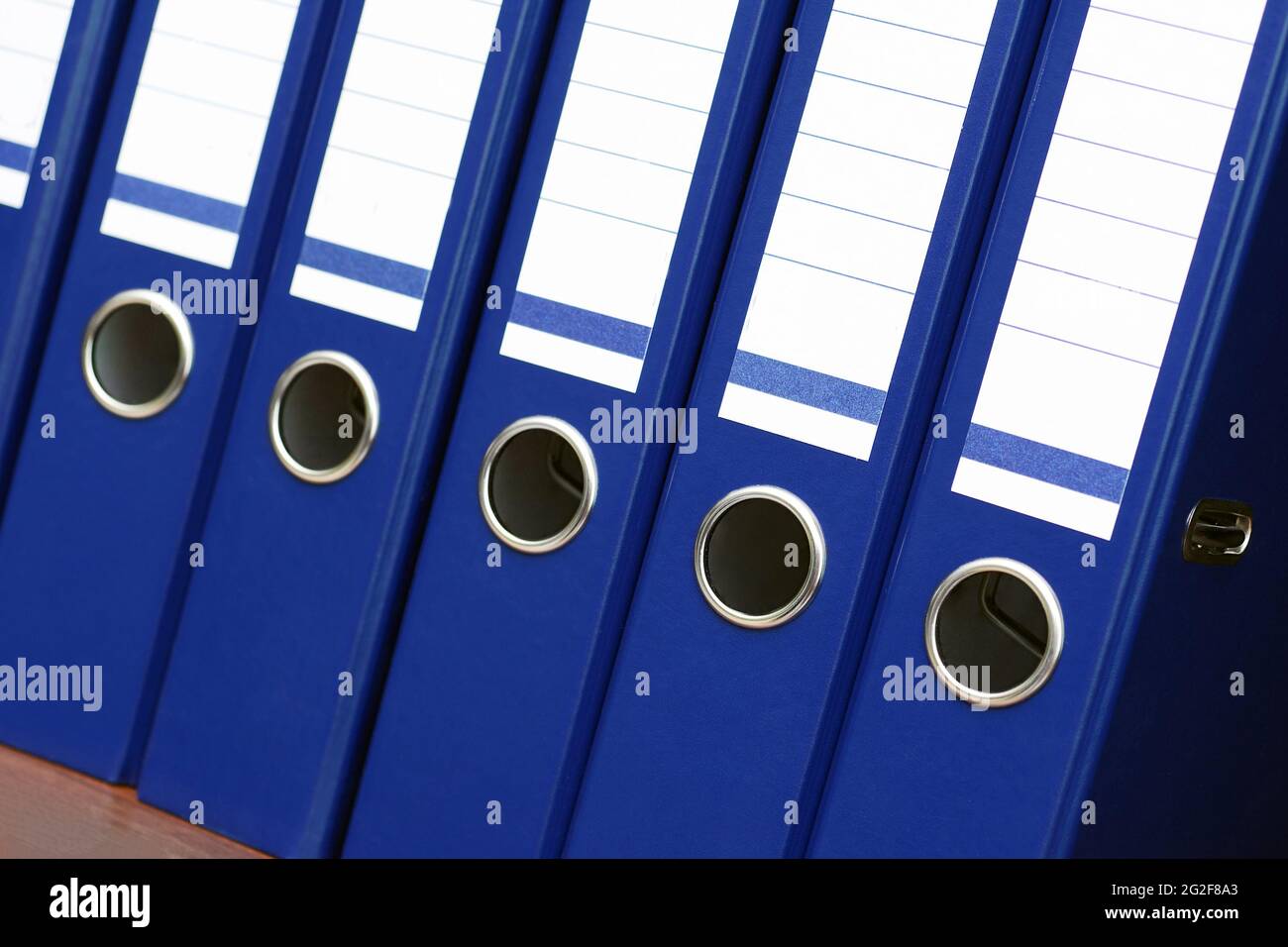 closeup of blue file binders in a row on a shelf Stock Photo - Alamy