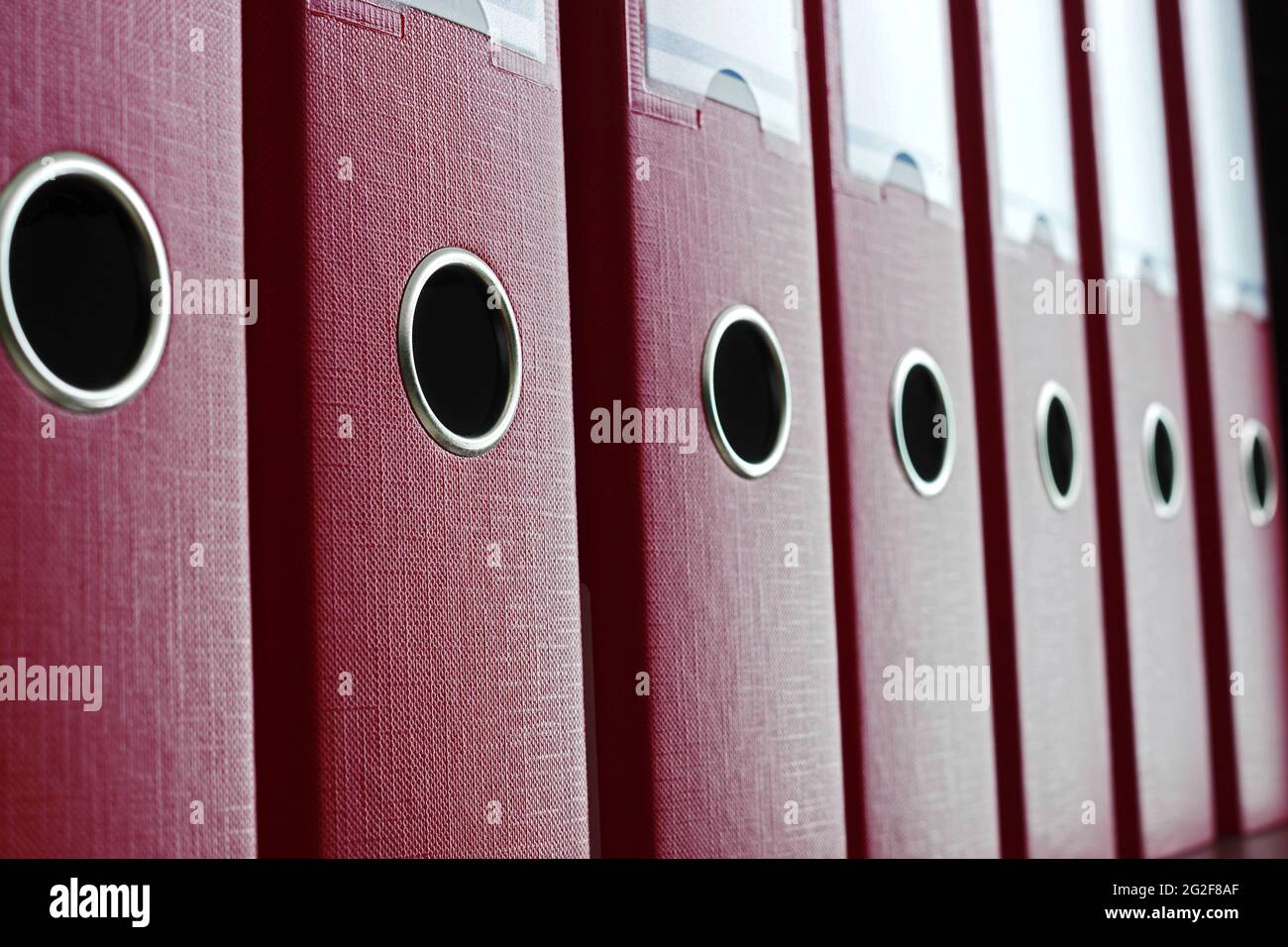 closeup of red file binders in a row on a shelf Stock Photo - Alamy