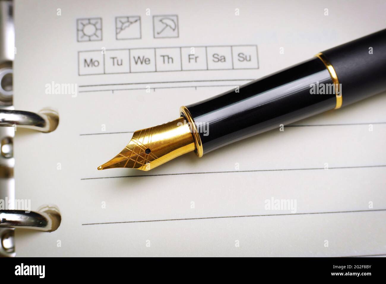 macro of black luxury gold plated fountain pen on open notebook Stock ...