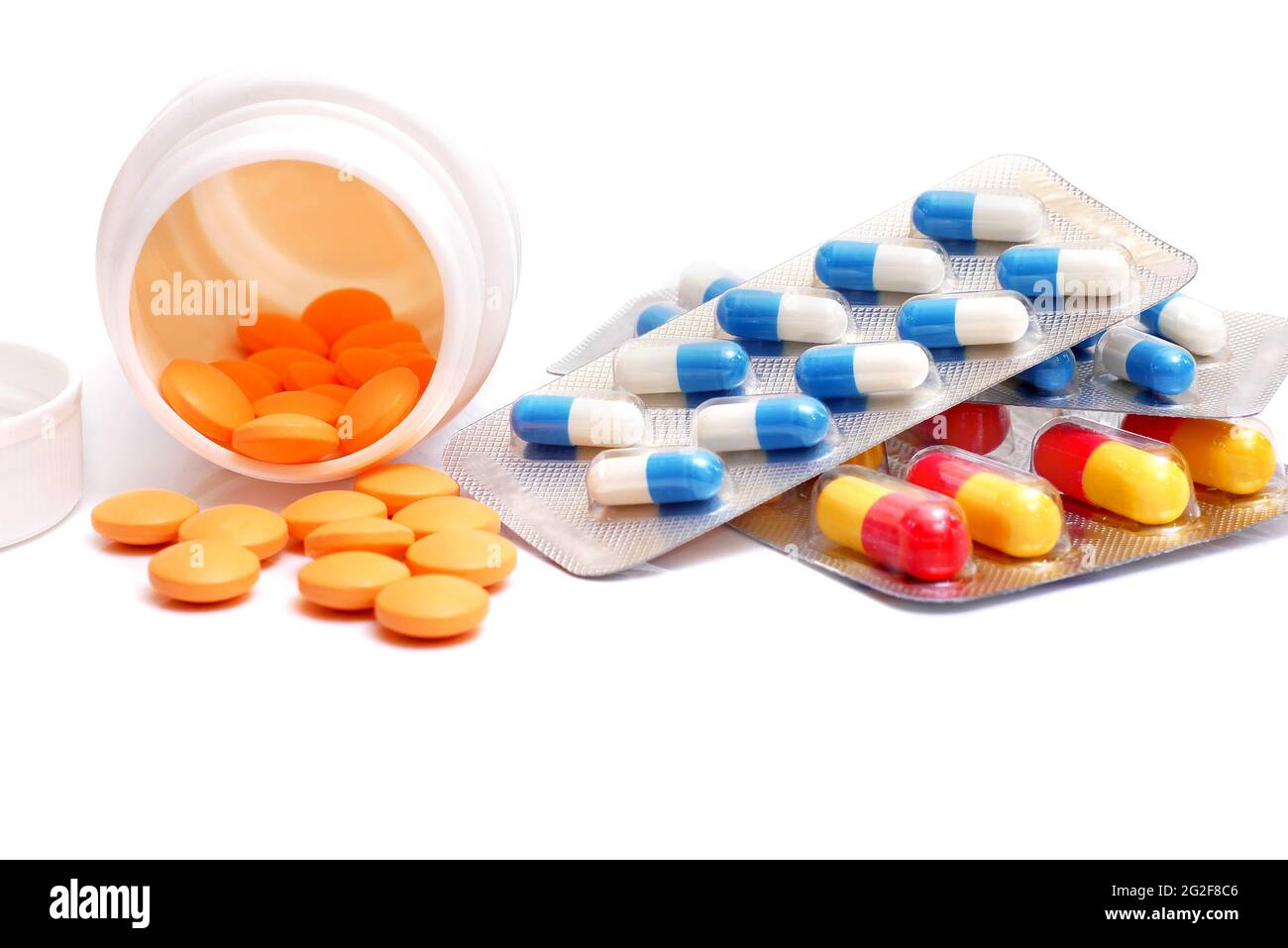 pills spilled from bottle and capsules in blister packs isolated on ...