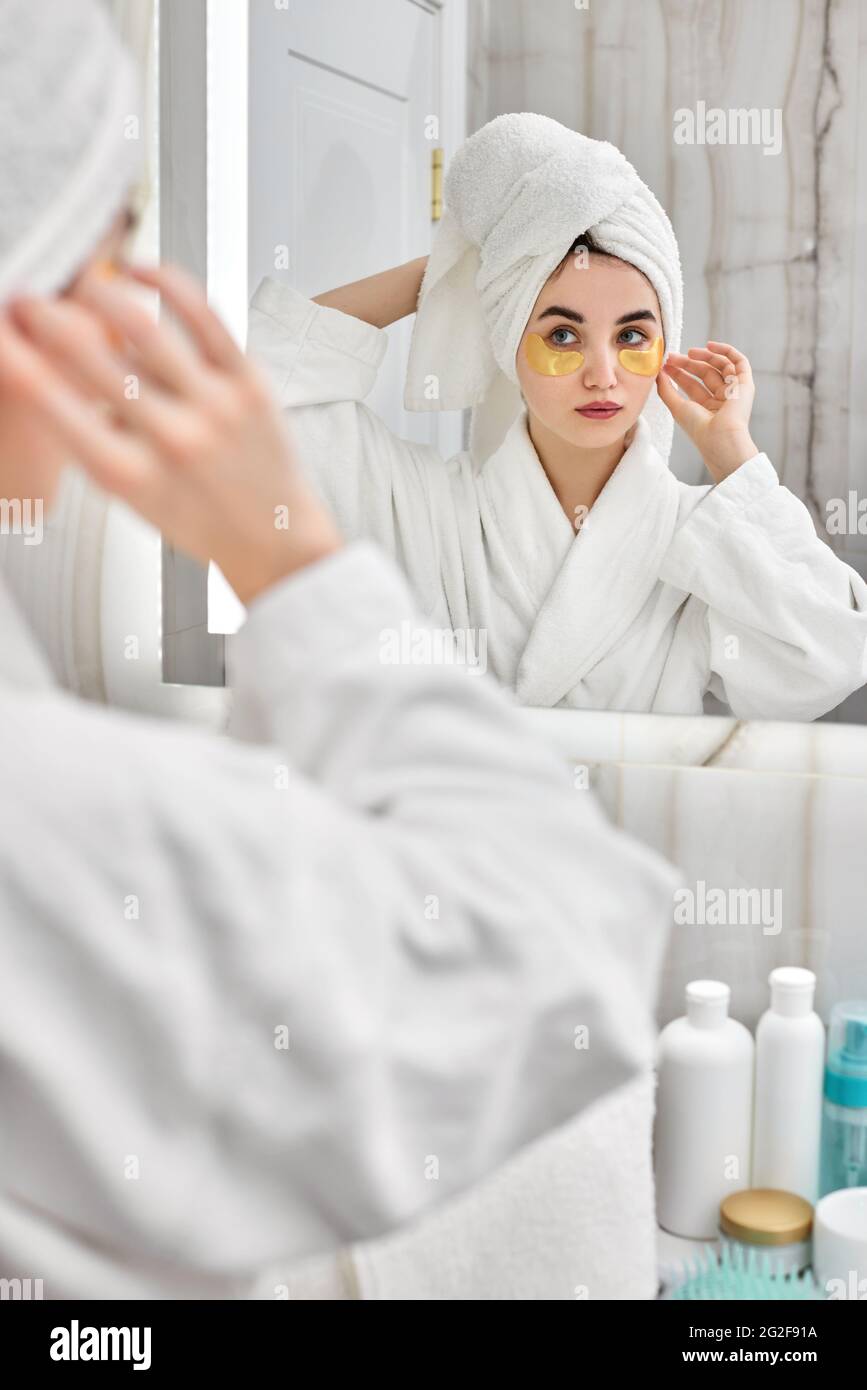 Beautiful Woman With Eye Patches In White Bathrobes In Bathroom Stock