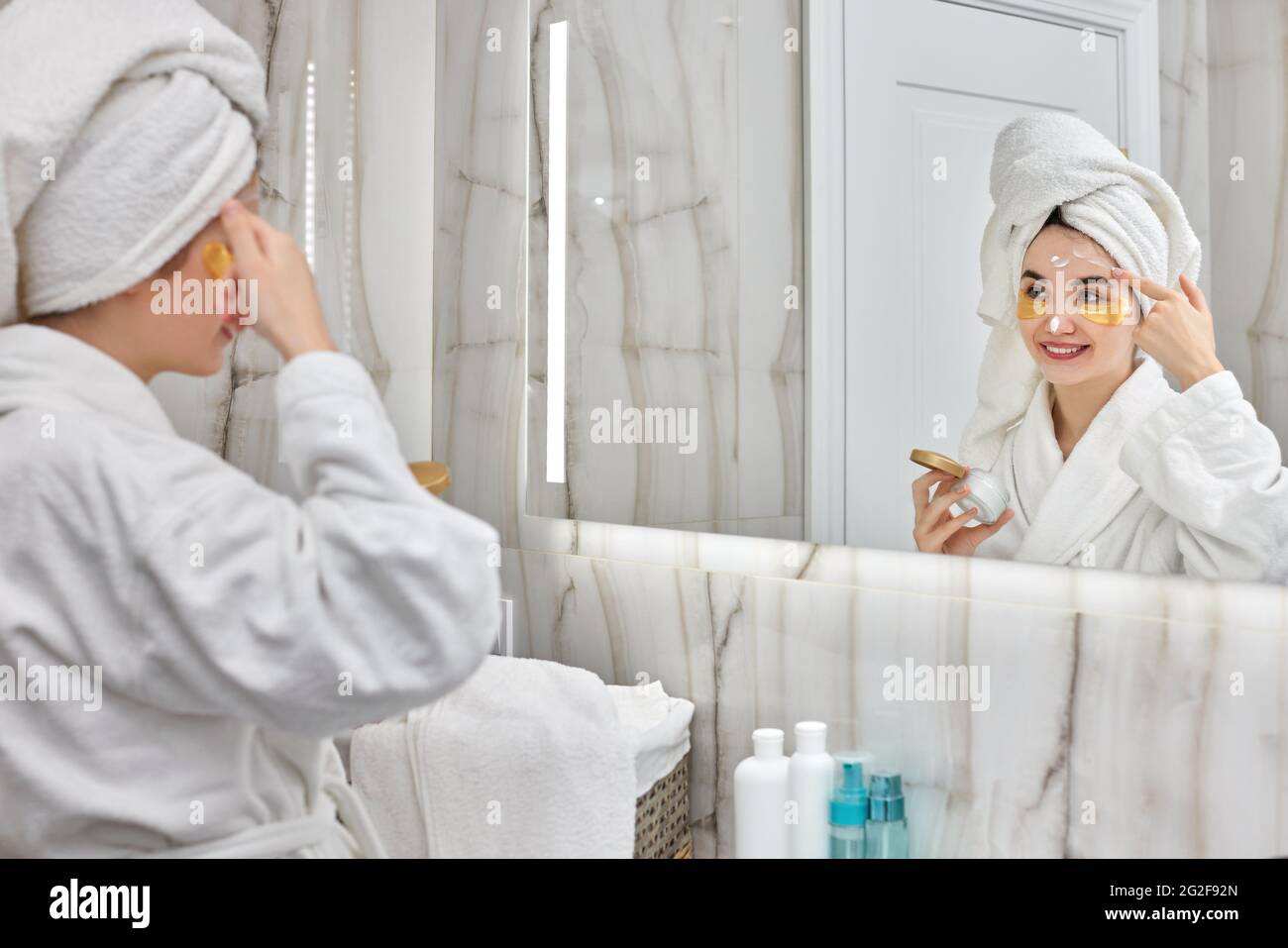 Beautiful Woman With Eye Patches In White Bathrobes In Bathroom Stock