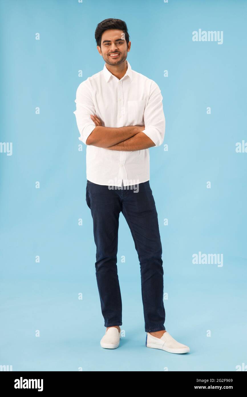 PORTRAIT OF A STYLISH YOUNG MAN STANDING IN FRONT OF CAMERA Stock Photo ...