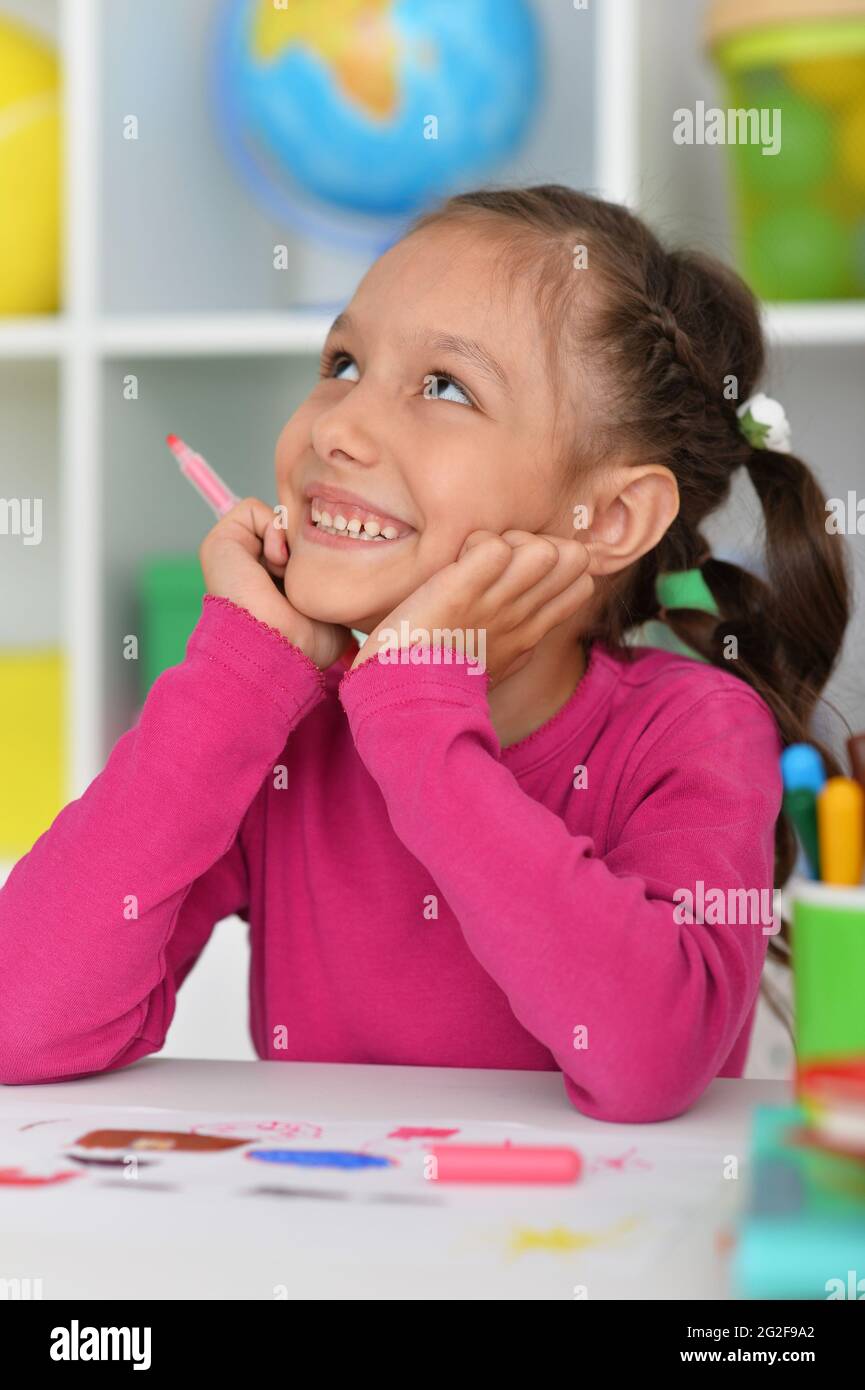 Porait of cute girl drawing picture at home Stock Photo - Alamy