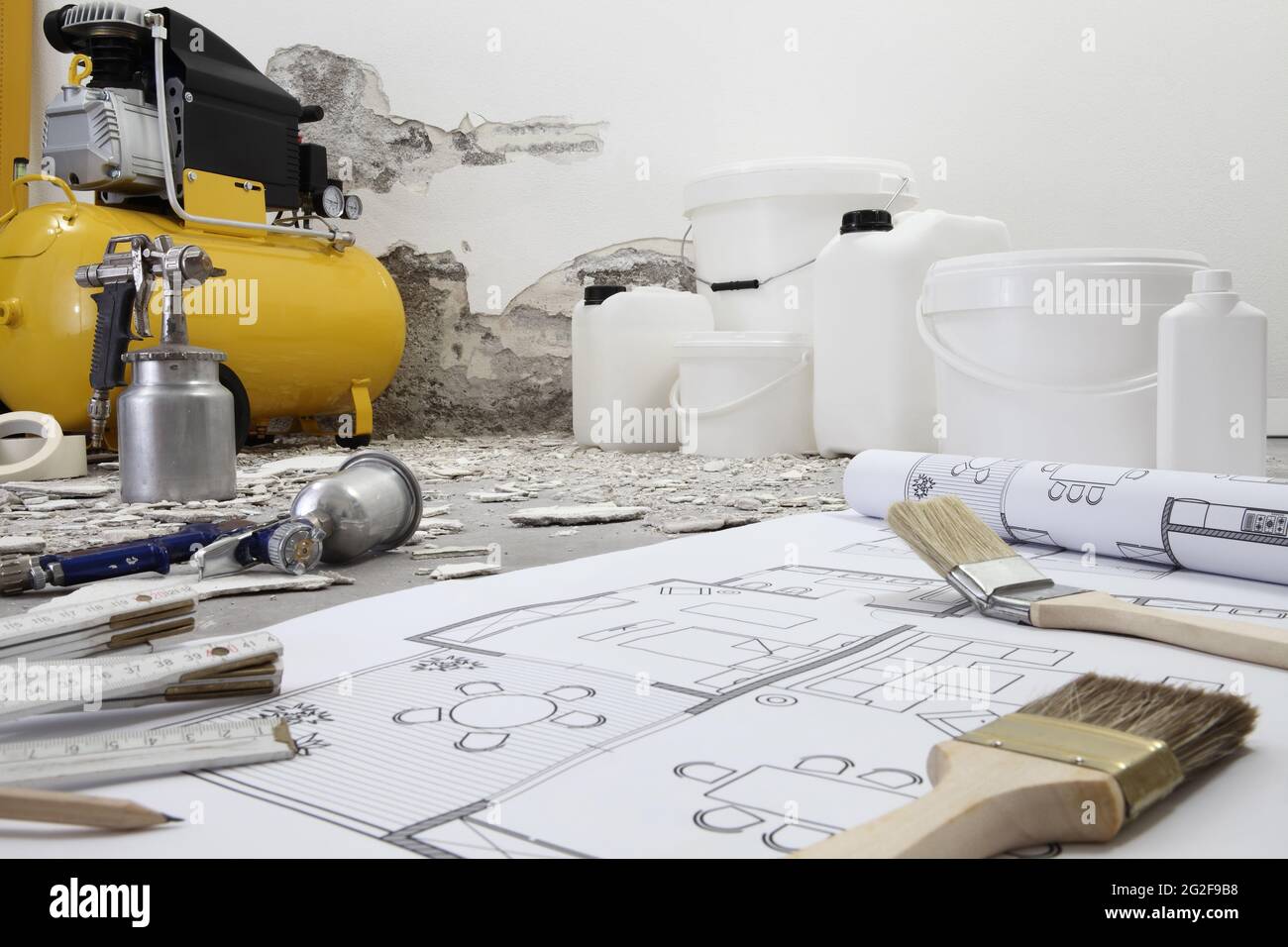 house renovation concept. Compressor with paint spray air gun. Buckets ...