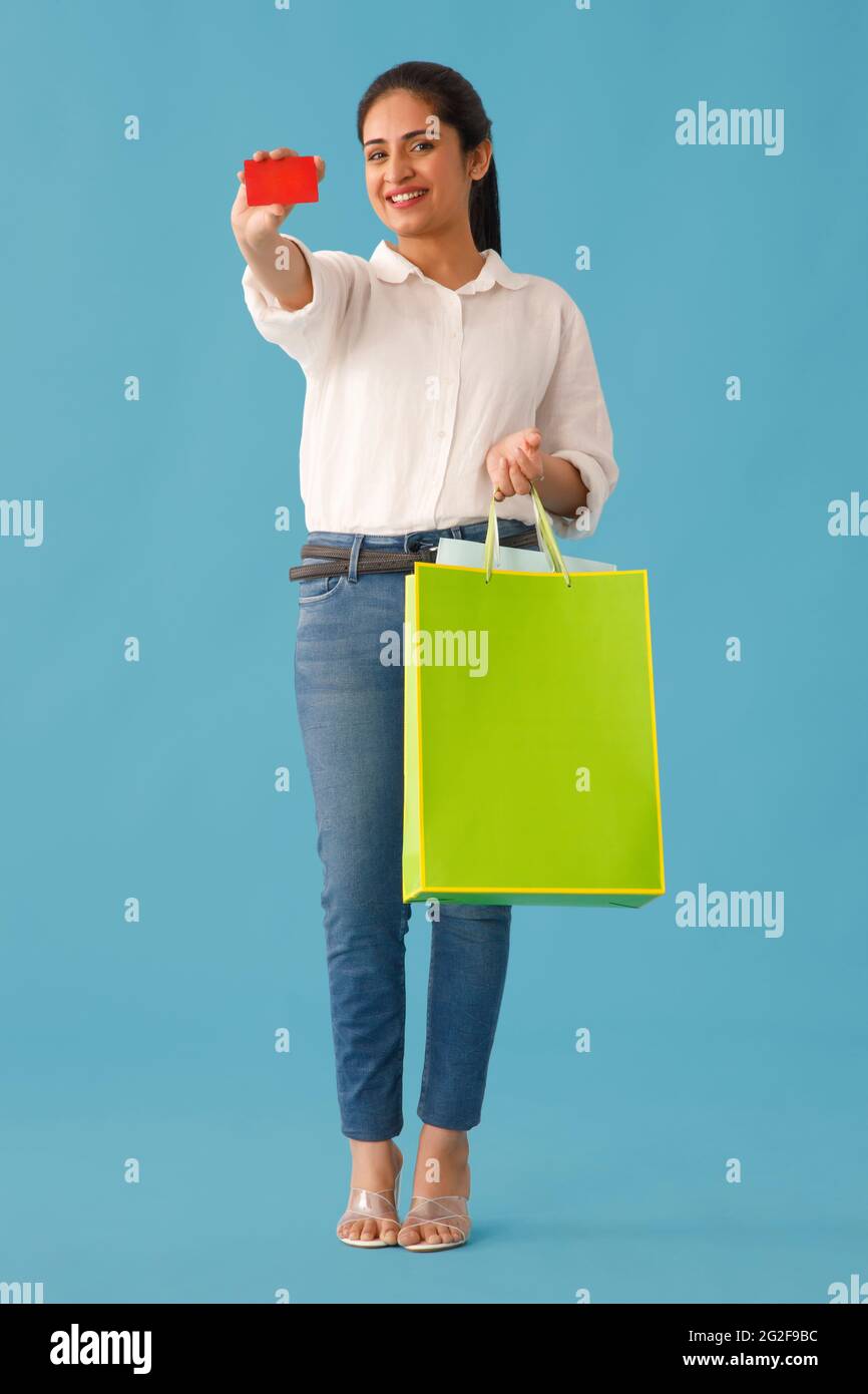 A YOUNG WOMAN HAPPILY SHOWING DEBIT CARD IN FRONT OF CAMERA Stock Photo ...