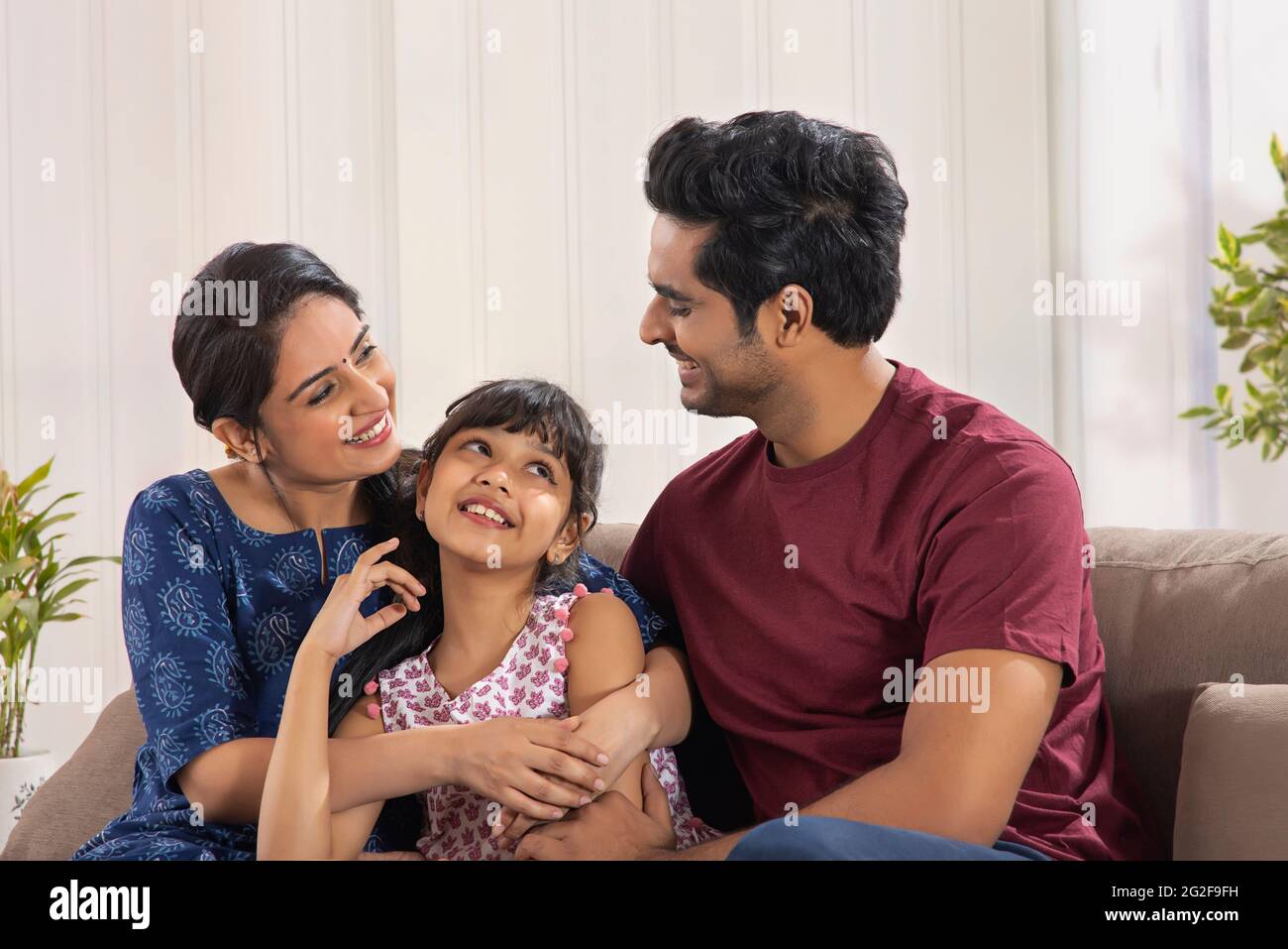 A HAPPY FAMILY SITTING AT HOME AND SPENDING TIME WITH EACH OTHER Stock ...