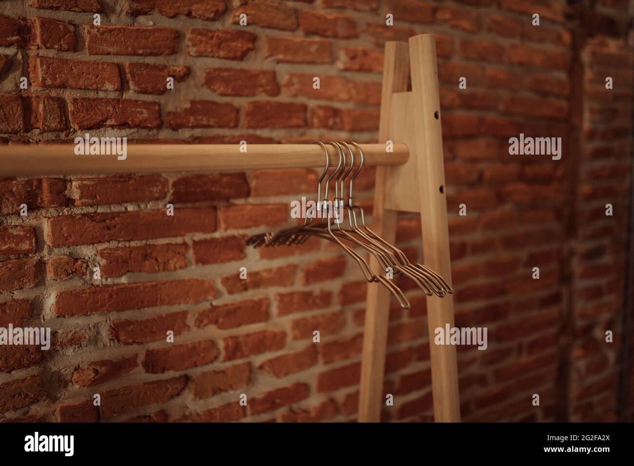 Closeup shot of a loft style wooden hanger on the brick wall background ...