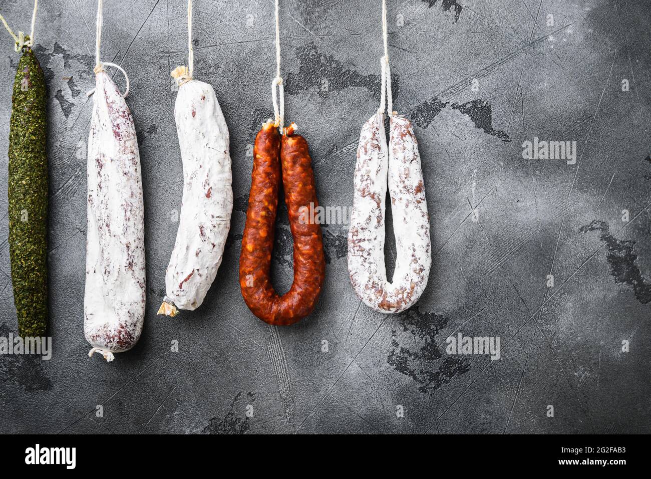 Spanish dry salami from a rack at market on grey background, topview ...