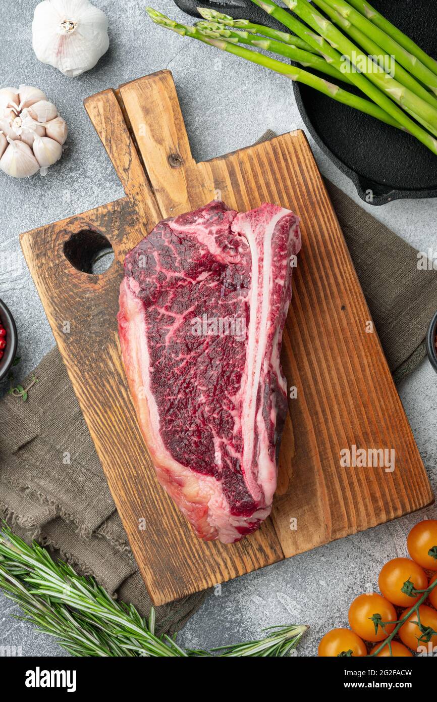 Dry aged Club Steak, seasoning, on gray stone background, top view flat ...