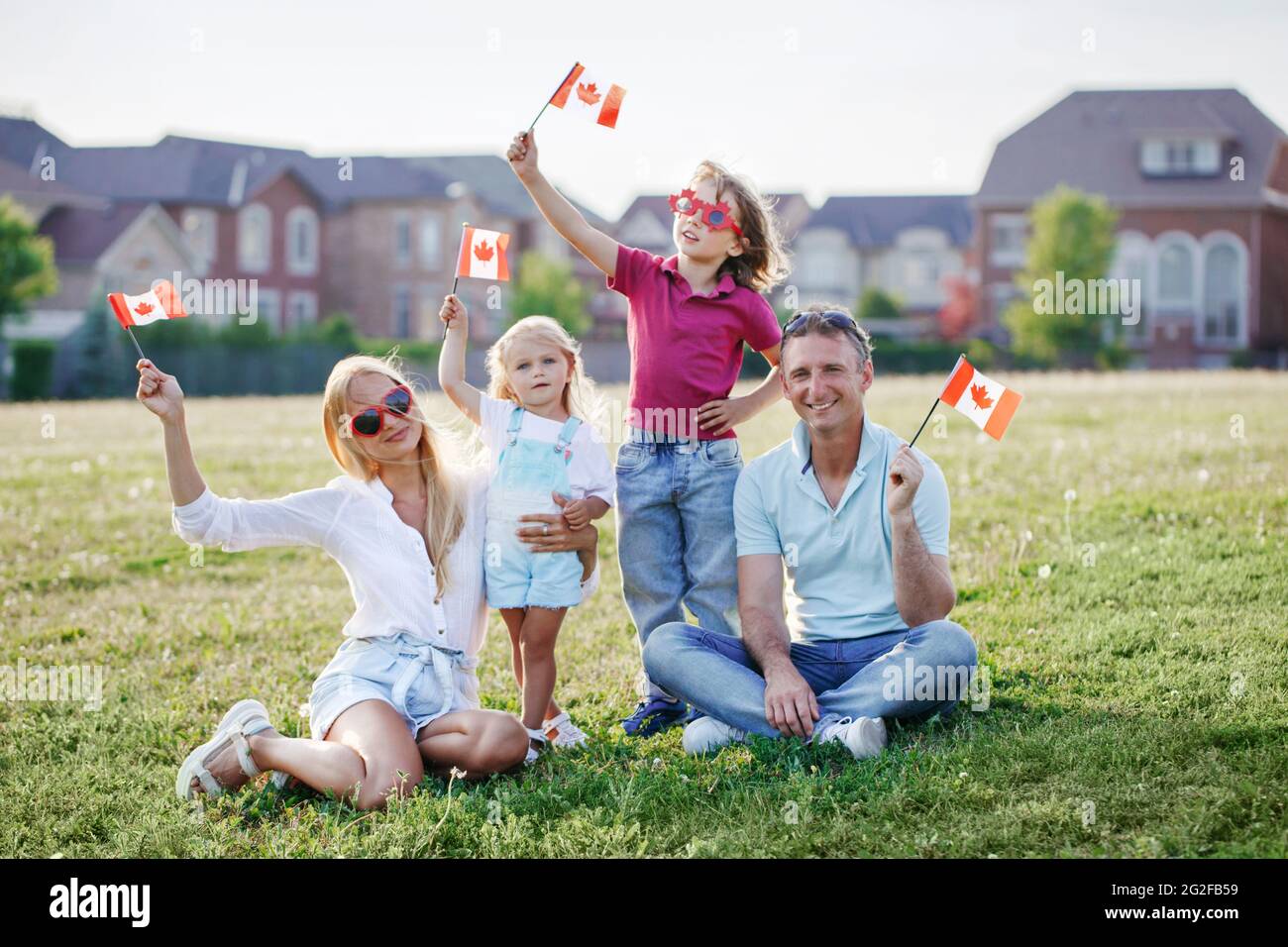 Happy Canada Day. Caucasian family with kids boy and girl sitting on ...