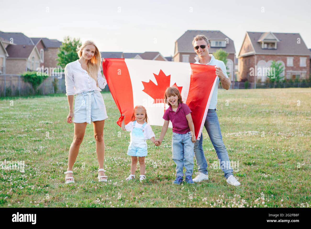 Happy Canada Day. Caucasian family with kids boy and girl standing in ...