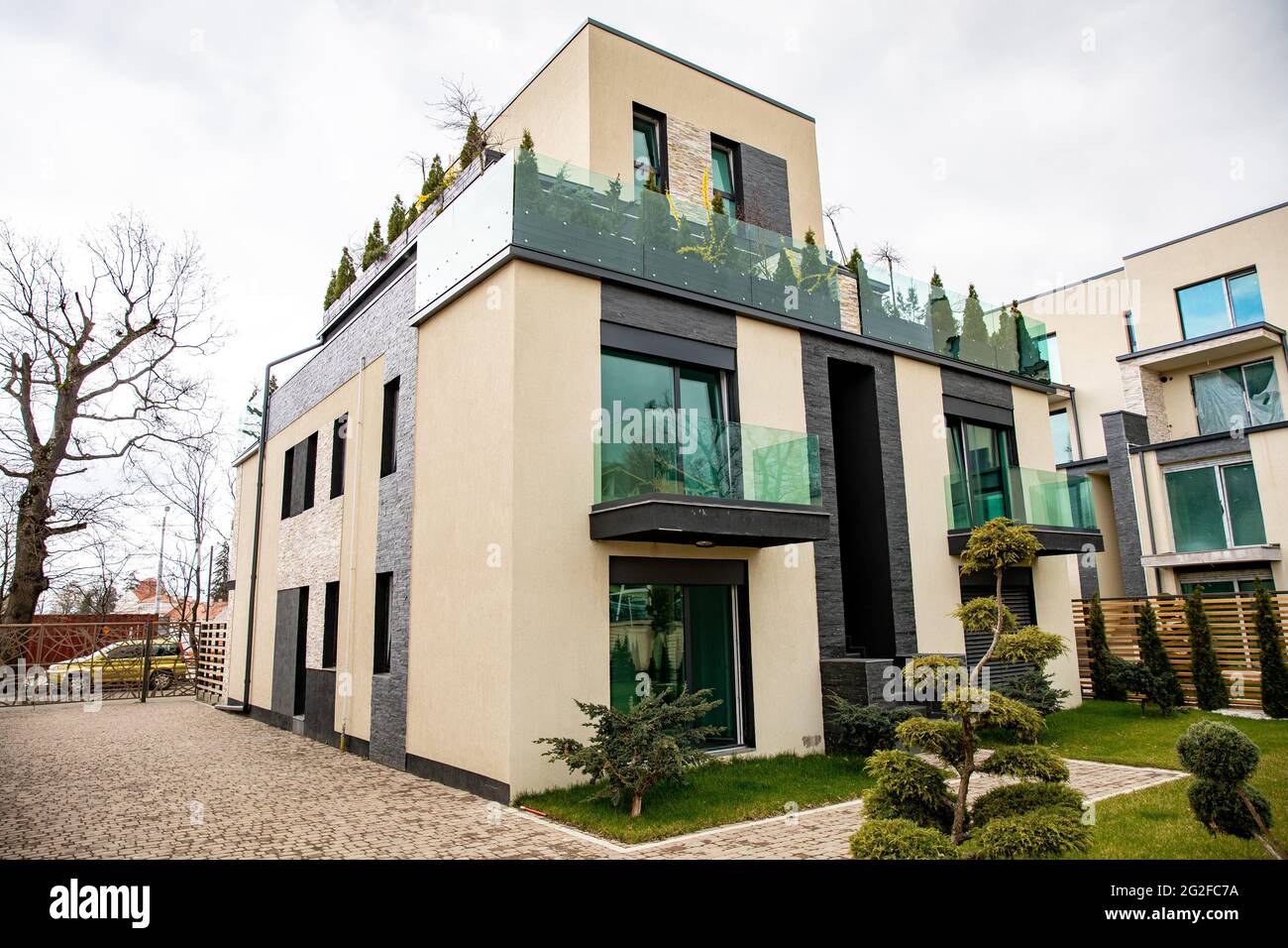 Newly built buildings in beige and white colors with a beautiful garden ...