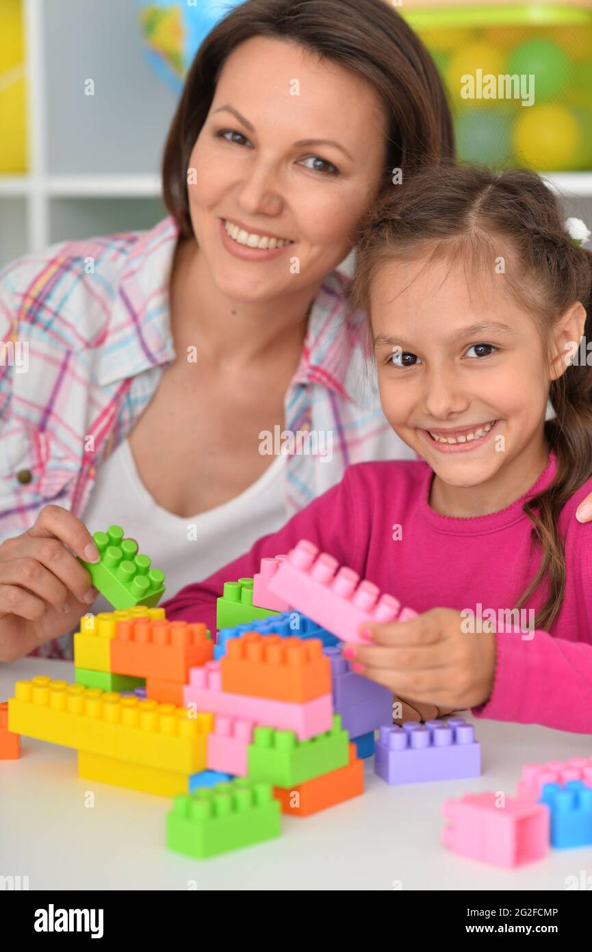 Cute little girl playing with colorful clay blocks at home Stock Photo ...