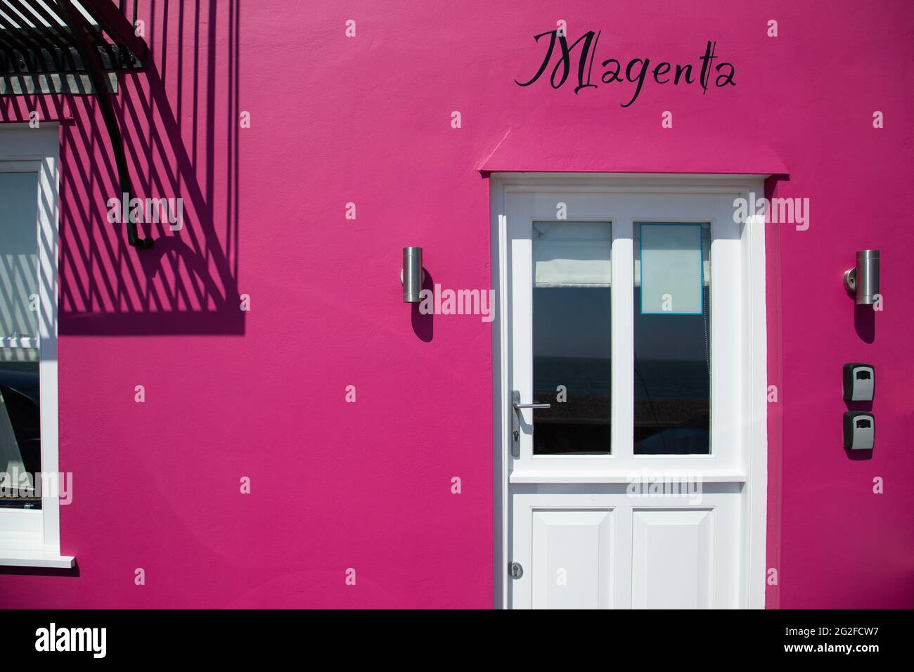 Magenta coloured old house. Front view. Colourful old UK house facade ...