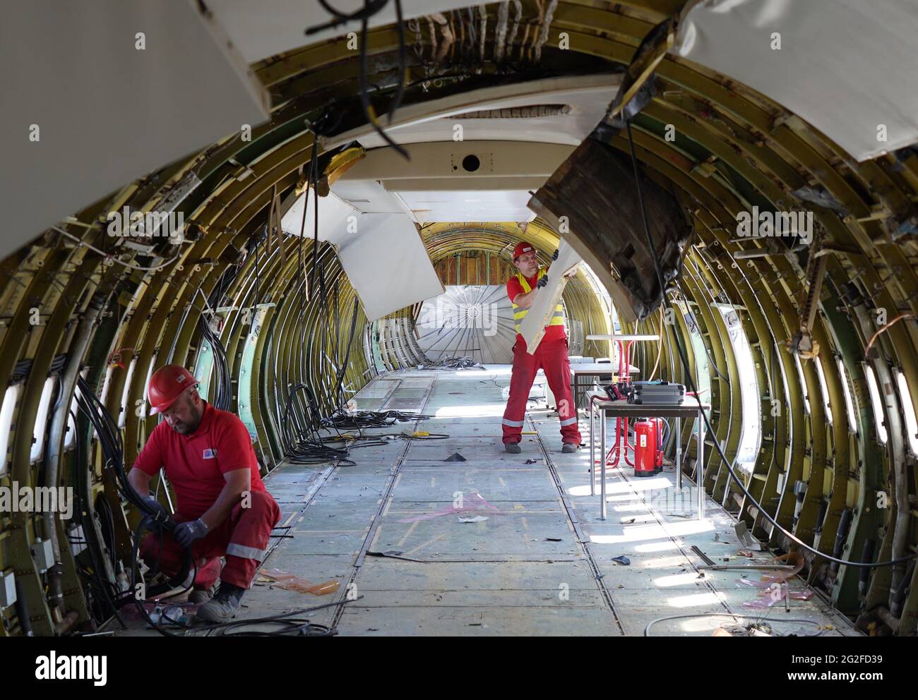 11 June 2021, Hamburg: Employees of a dismantling company remove cables ...