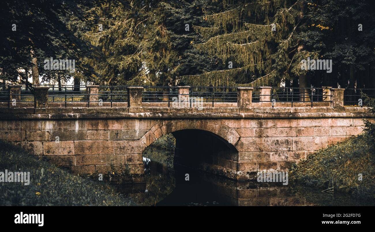 Gloomy landscape with an old stone footbridge Stock Photo - Alamy