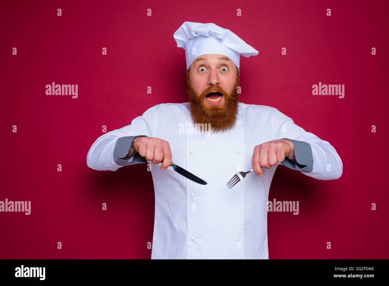 shocked chef with beard and red apron is ready to cook Stock Photo - Alamy